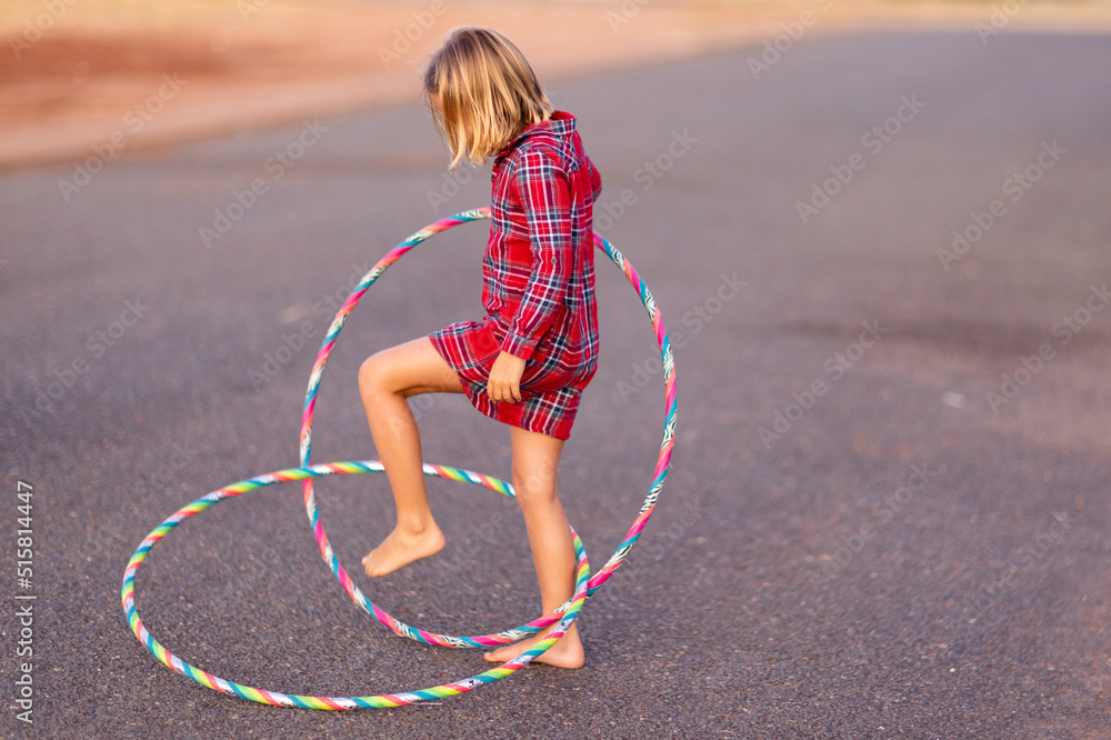 little girl playing with hoops outside Stock Photo | Adobe Stock