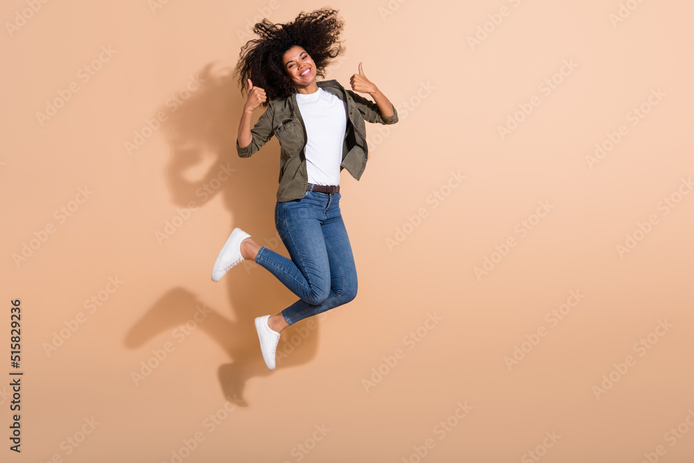 Full length body size view of attractive cheerful girl jumping showing ...