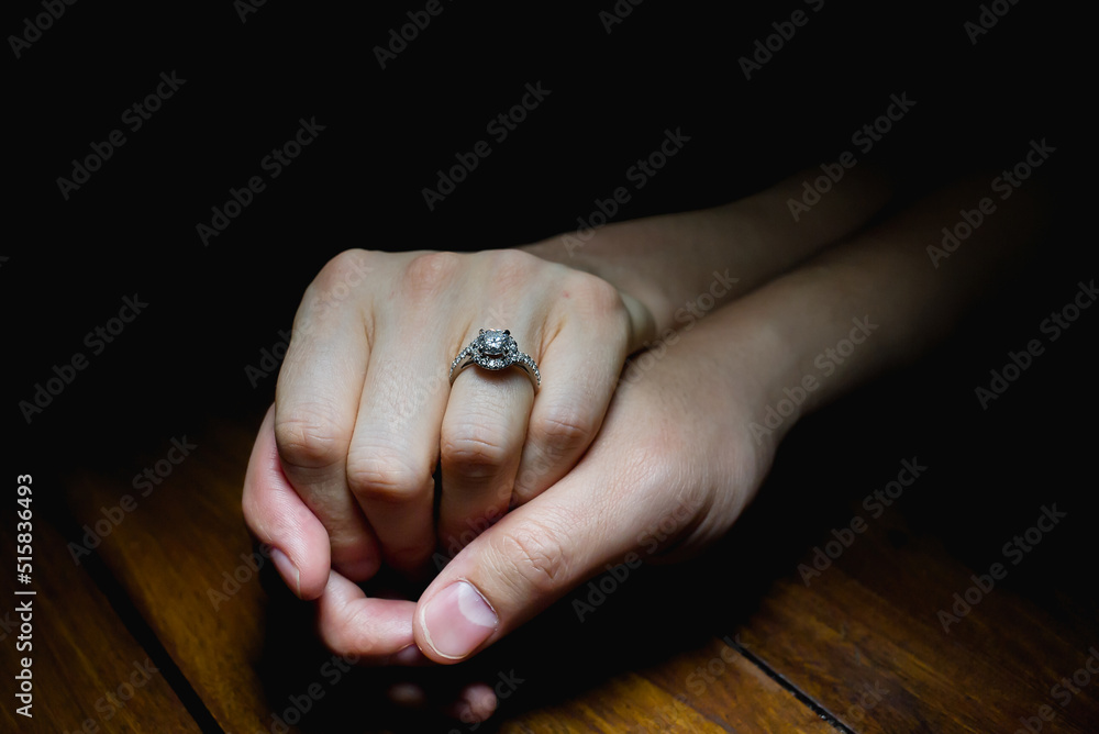 woman bride wears a wedding ring on the left ring finger of the groom's ...