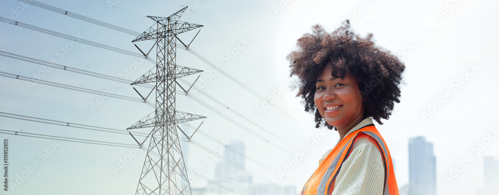 Professional electrical engineers work near high voltage poles. African ...