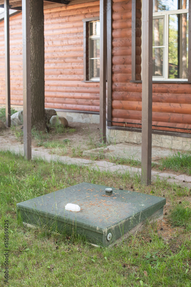 Square metal cover of an autonomous septic tank with a warning lamp on ...