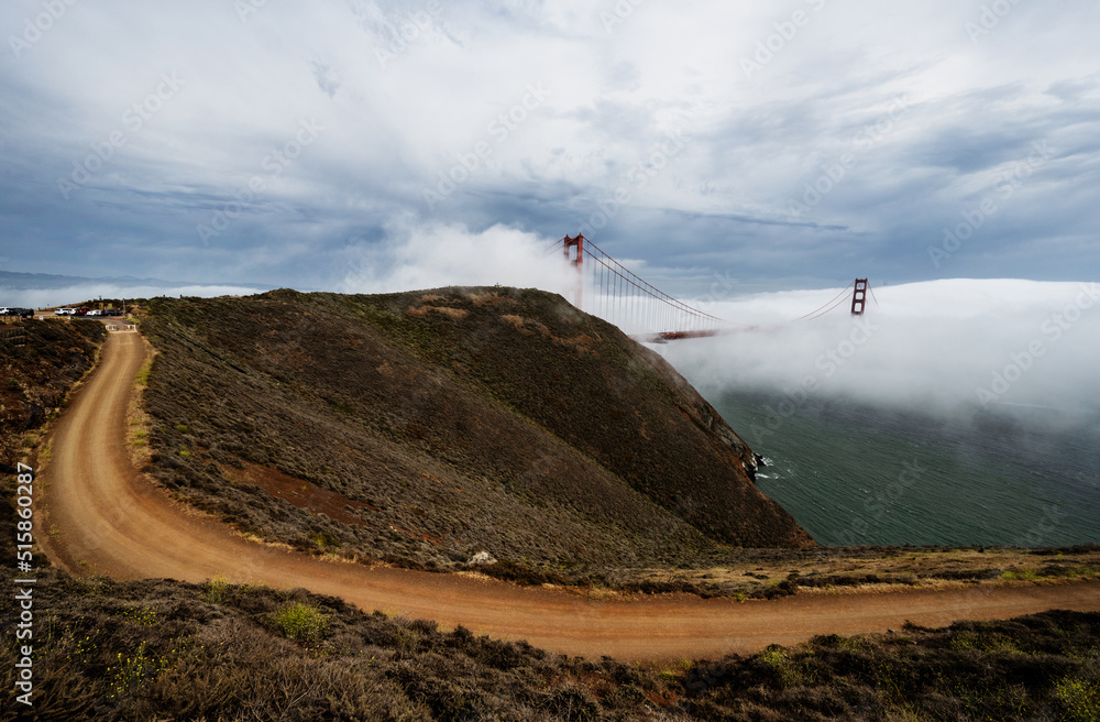 Road through Golden Gate bridge recreation area with the golden gate ...