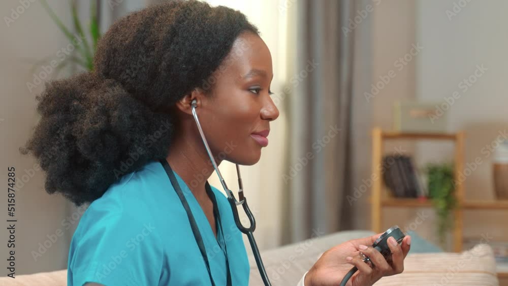 Close up shot of beautiful young African American woman nurse checking ...