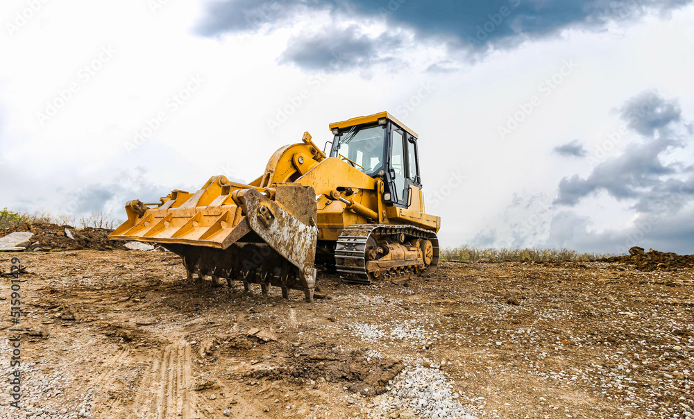 Track bulldozer, earth-moving equipment at construction site on dull ...