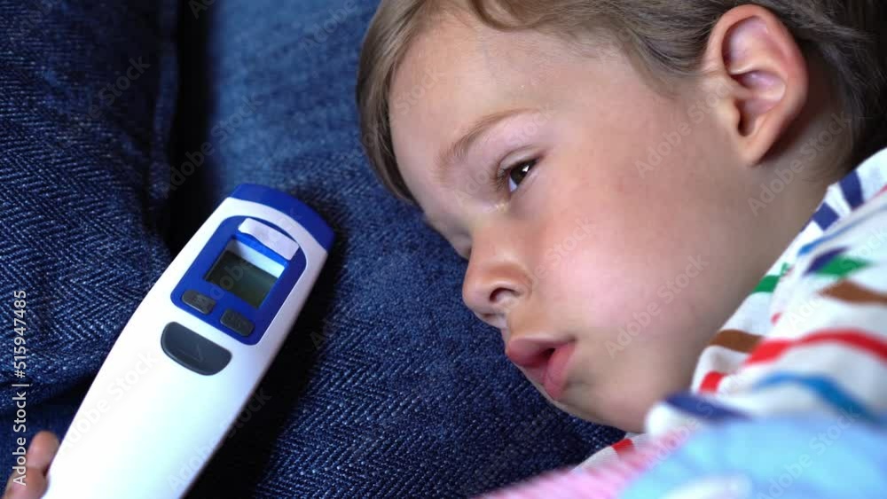Portrait of sick ill little preschool child boy. Measuring body Hight ...