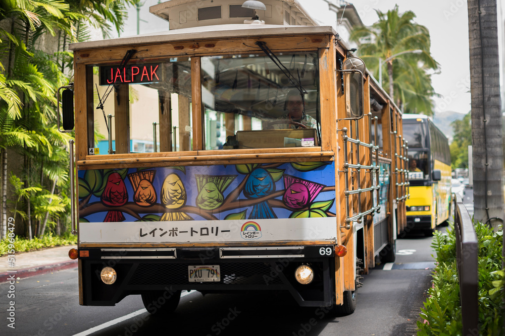 Waikiki Trolley in the streets of Oahu. The front of it shows Heather ...