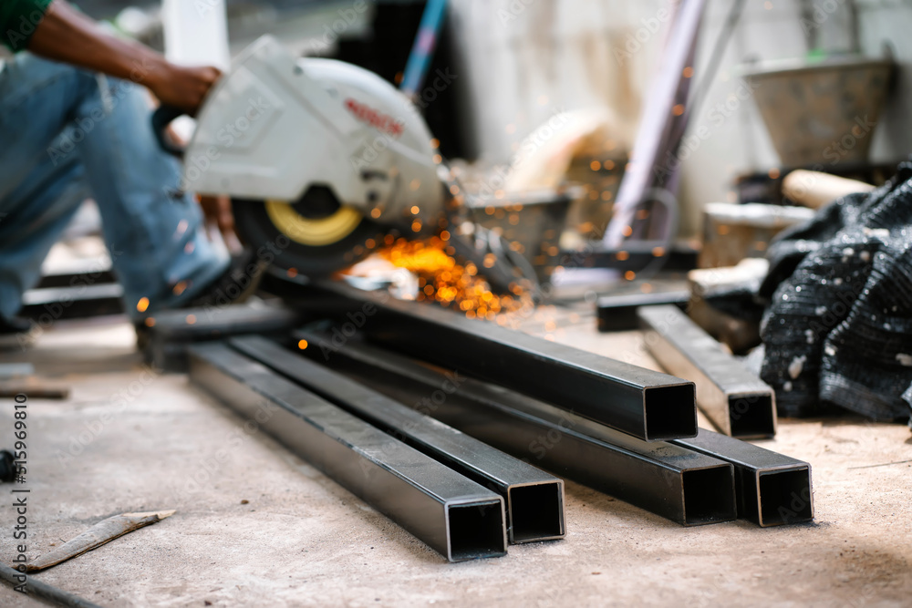 Steel welders welding large warehouse roof steel structures with ...