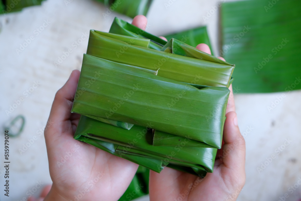 Raw Buras in the hands of women before cooking. Buras is one of the ...