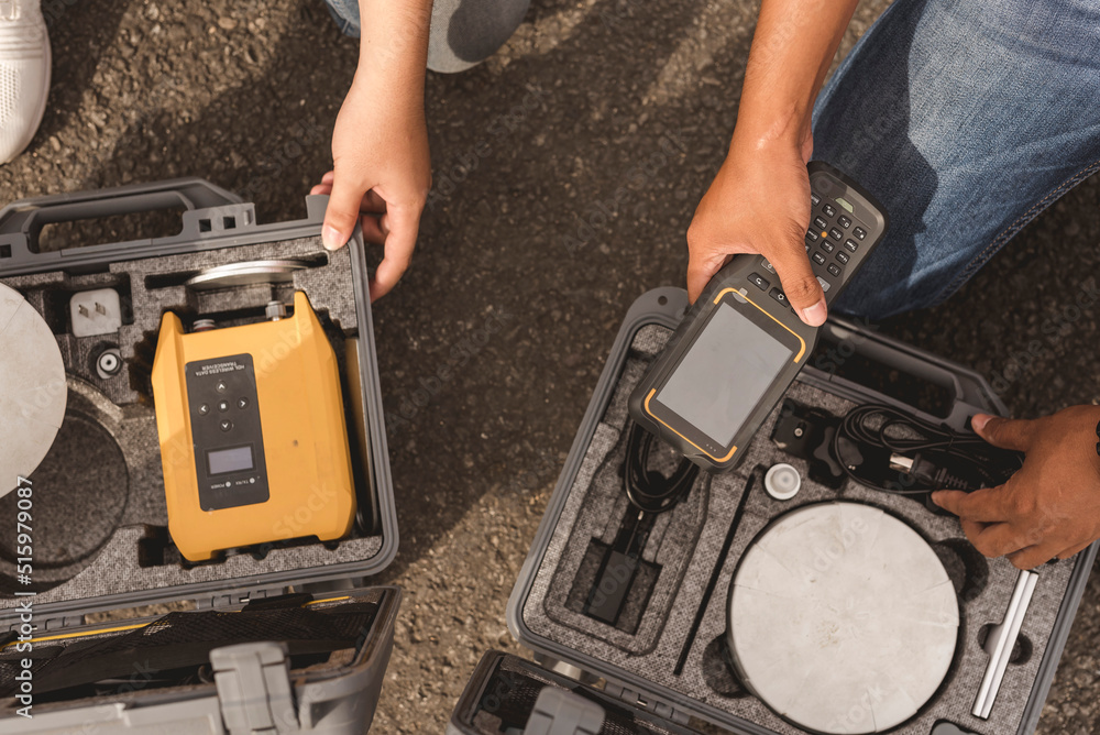 Surveryors setting up real-time kinematic or RTK geodetic surveying ...