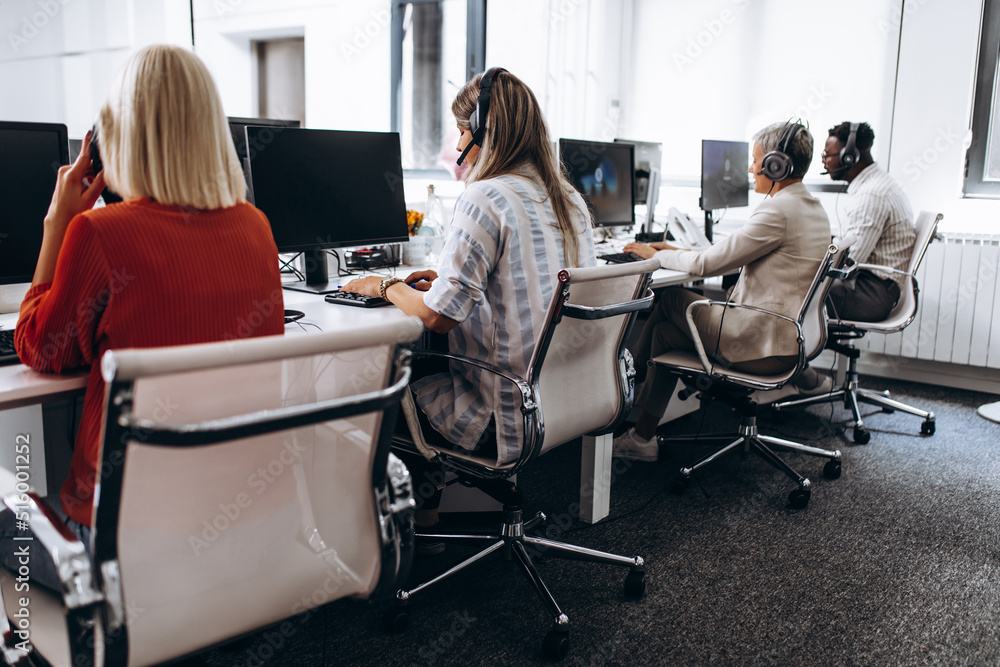 Team of call center employees working together in office. Stock Photo ...