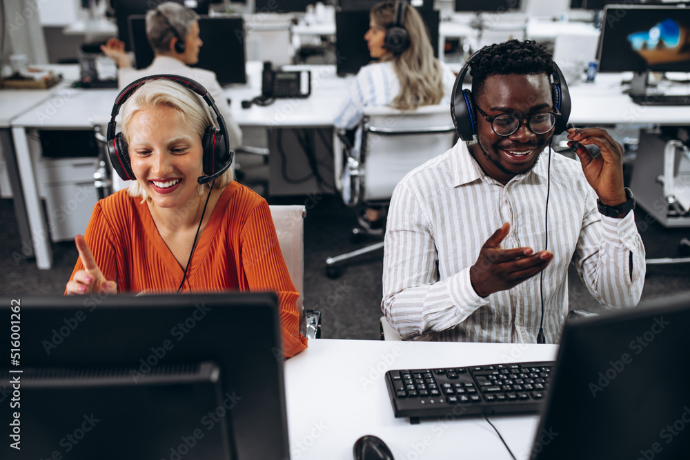 Team of call center employees working together in office. Stock Photo ...