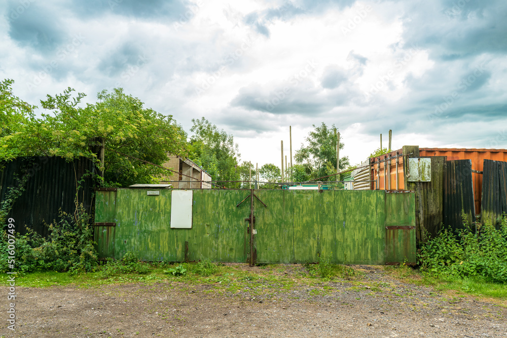 Makeshift, large wooden gate complete with letterbox at the entrance to ...