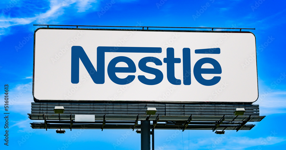 Advertisement billboard displaying logo of Nestle Stock Photo | Adobe Stock