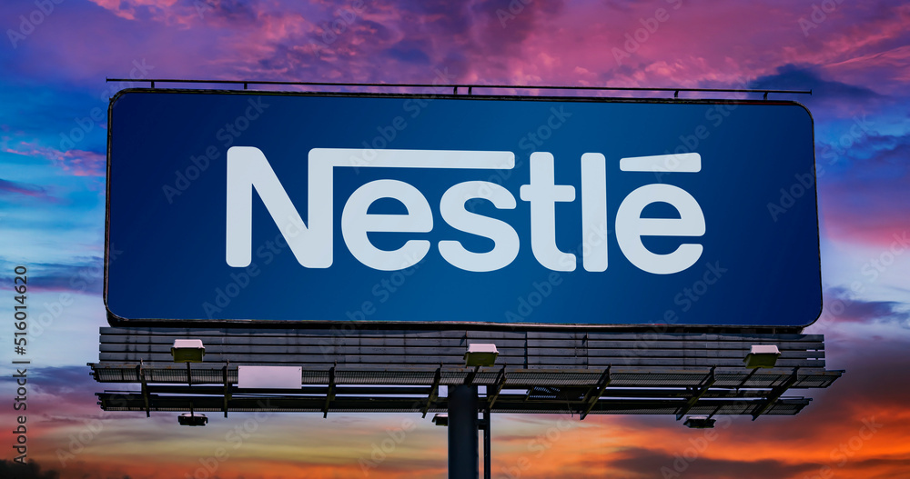 Advertisement billboard displaying logo of Nestle Stock Photo | Adobe Stock