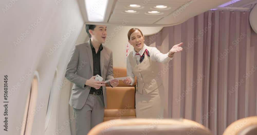 Before a flight, a female flight attendant or air hostess in uniform ...