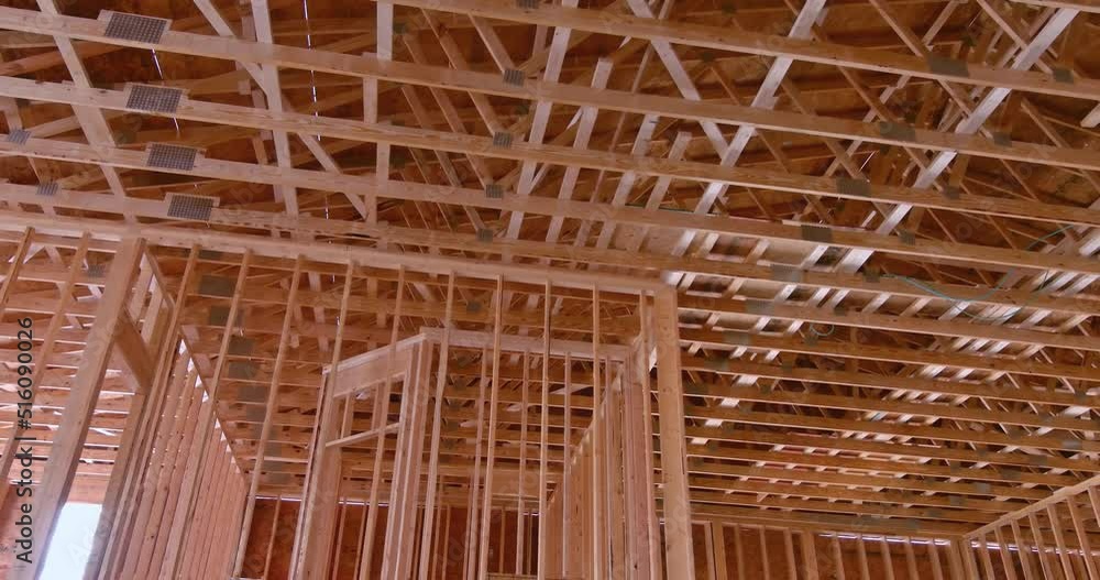 New wooden building with wood beams and roof trusses under construction ...