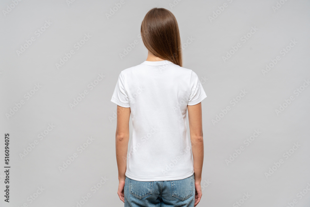 Back view of woman in white t-shirt, isolated on gray background ...