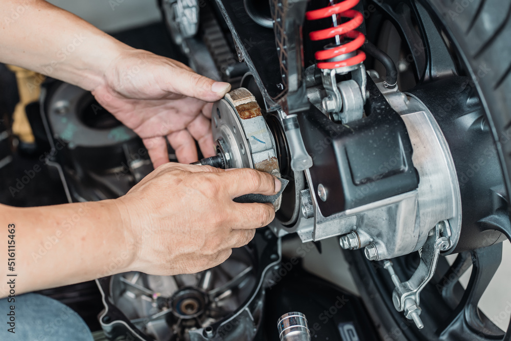 Motorcycle mechanic cleaning clutches with sandpaper. check the ...