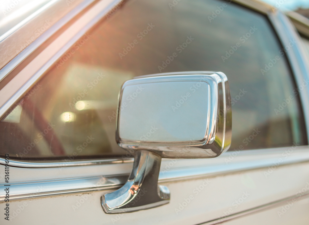Classic car background. Close-up of the side mirror of a classic design ...