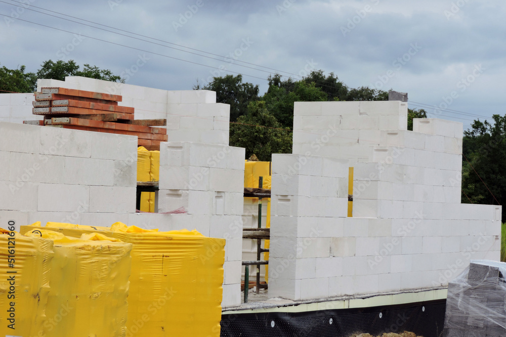 A house under construction, walls made of acc blocks, rough windows and ...