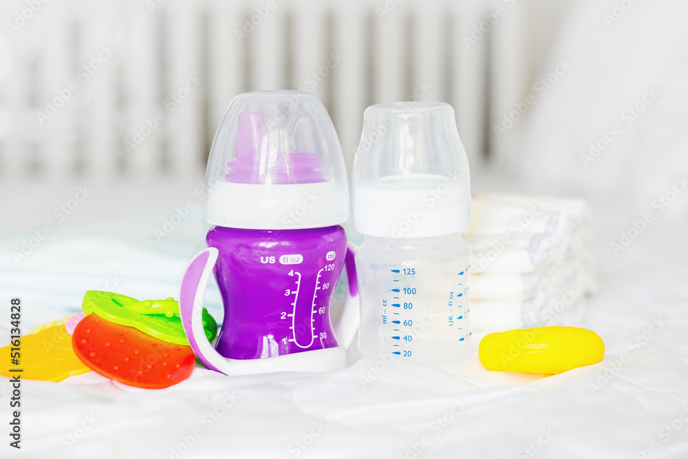 Two types of baby water bottles transparent and colored, toys and ...