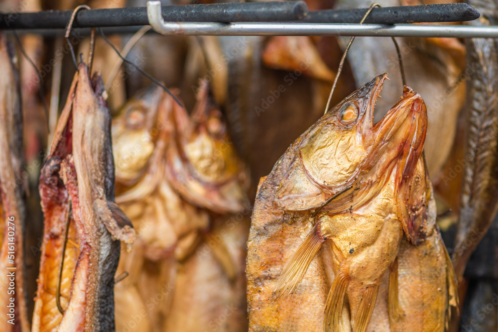 Hanging smoke-dried various fish in a fish market just smoked with ...