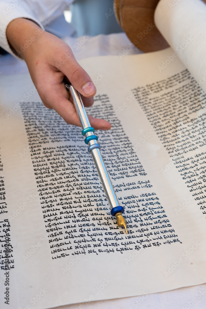 A boy reading from the Torah during his bar mitzvah celebration in ...