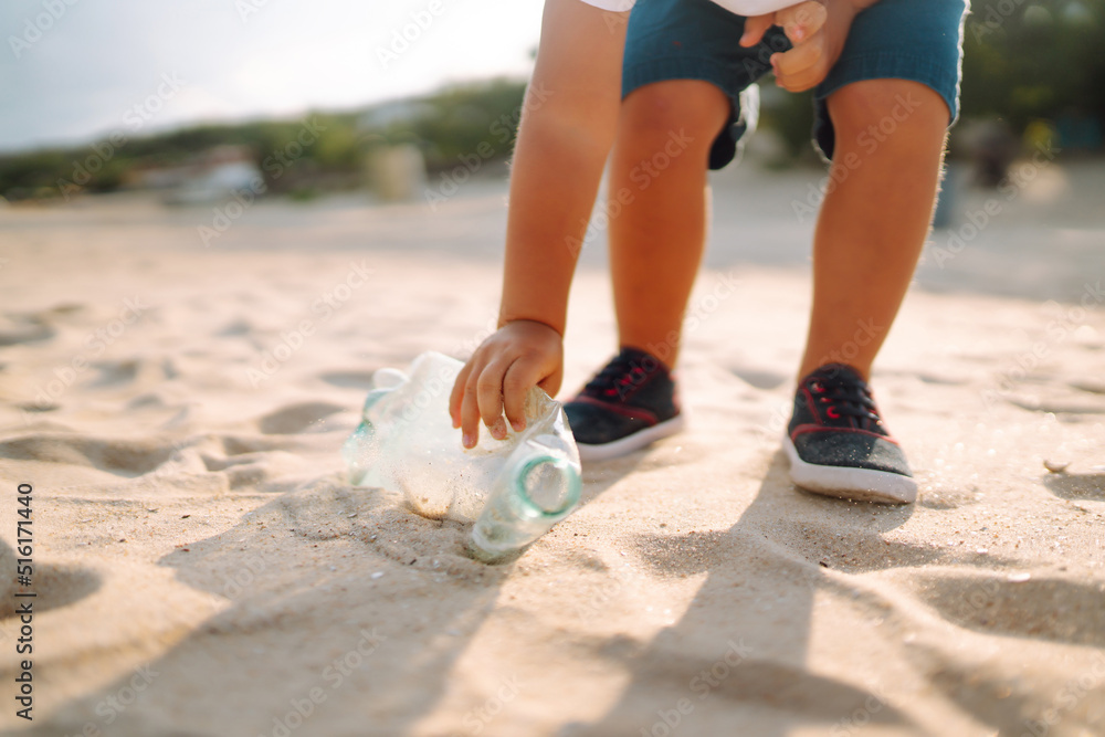 Trash on the beach. Scavengery. Child with mother collects plastic ...