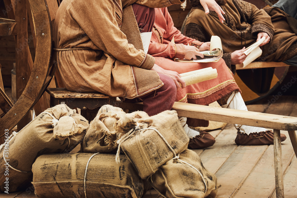 A man in vintage medieval clothes with a paper letter in his hand ...