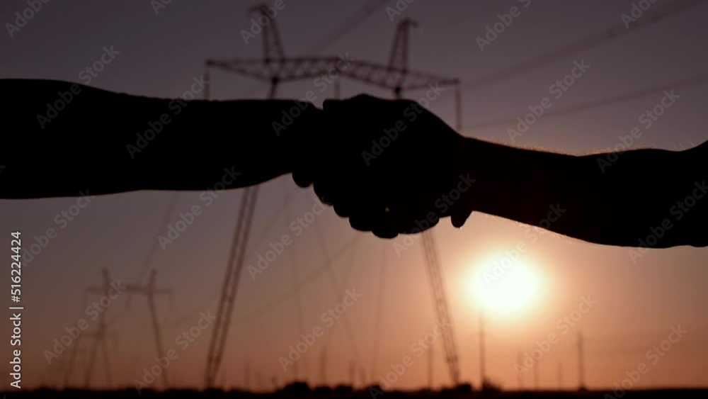 Video Stock Handshake of two electrical engineers against the backdrop ...