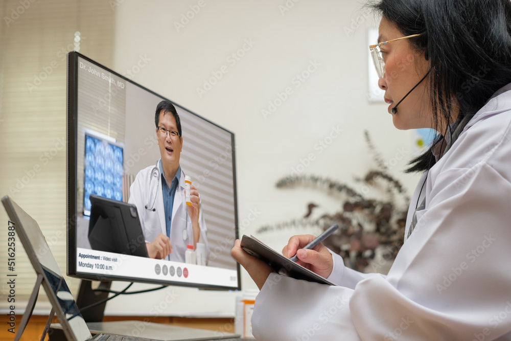 Asian woman doctor video conference discussion with doctor team about ...