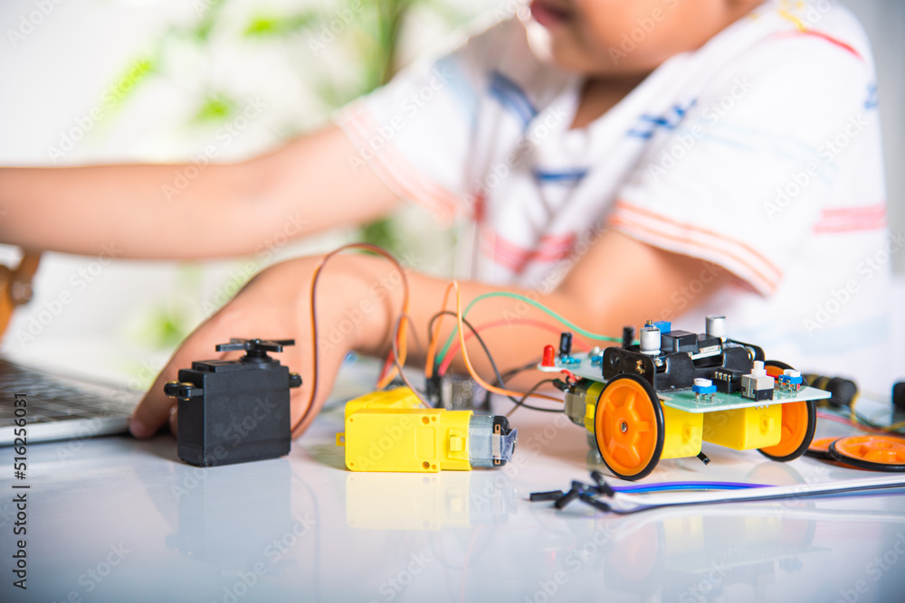 Foto de Asian kid boy learns coding and programming with laptop for ...