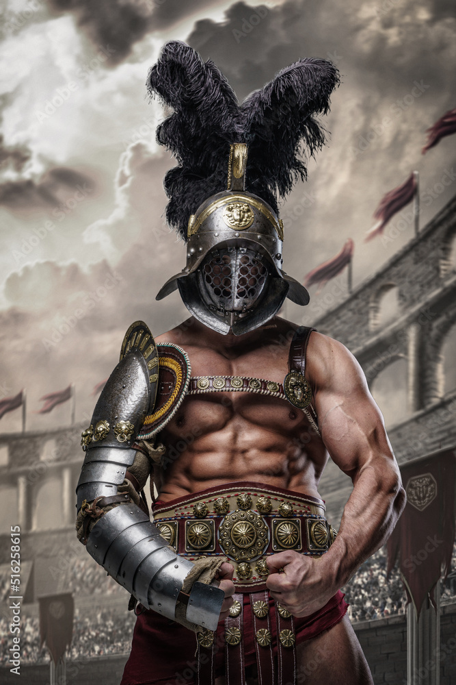 Shot of muscular gladiator dressed in armor and helmet posing showing ...
