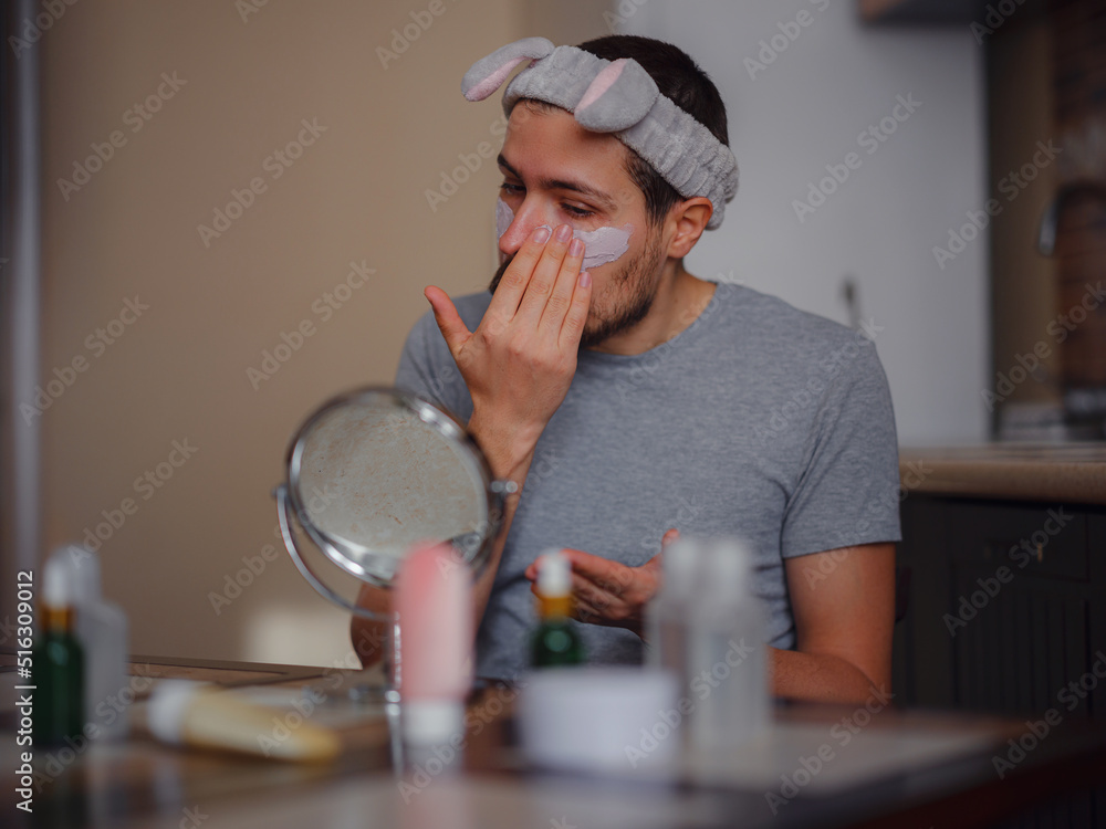 Men's beauty concept. caucAsian guy checking his skin. man looking into ...