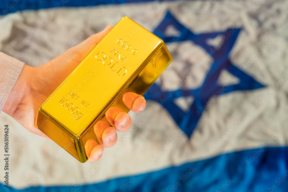 gold reserve of the Israel concept. Gold bar in hand on israeli flag ...