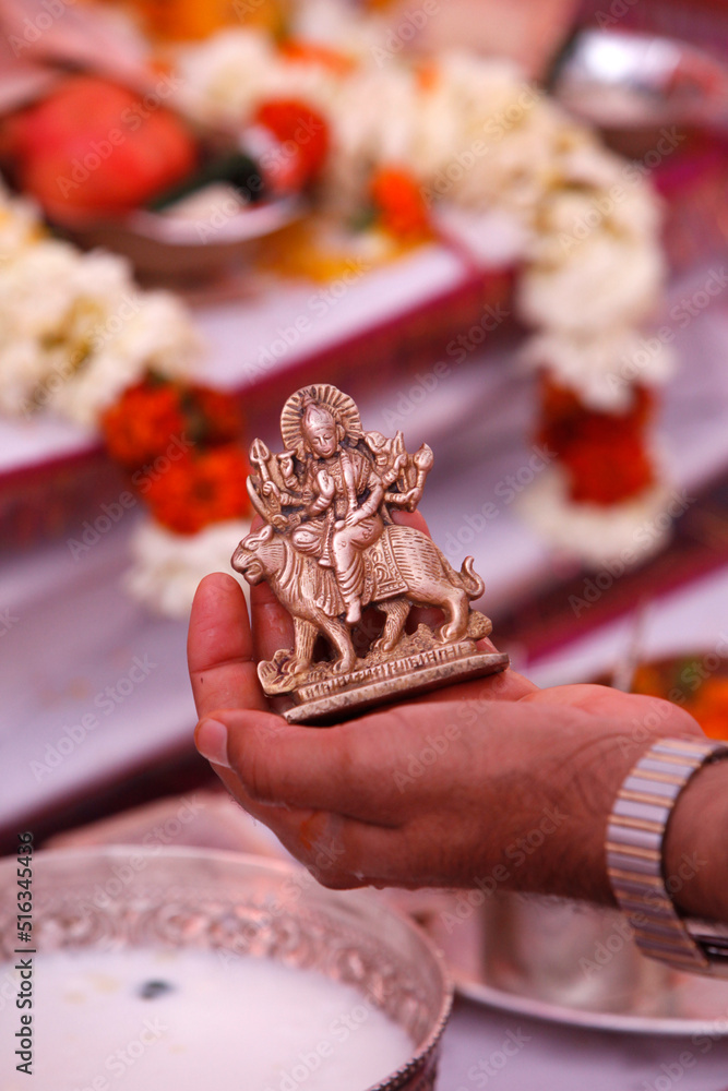 Puja in a Hindu temple : statue of goddess Durga held by the pujari ...