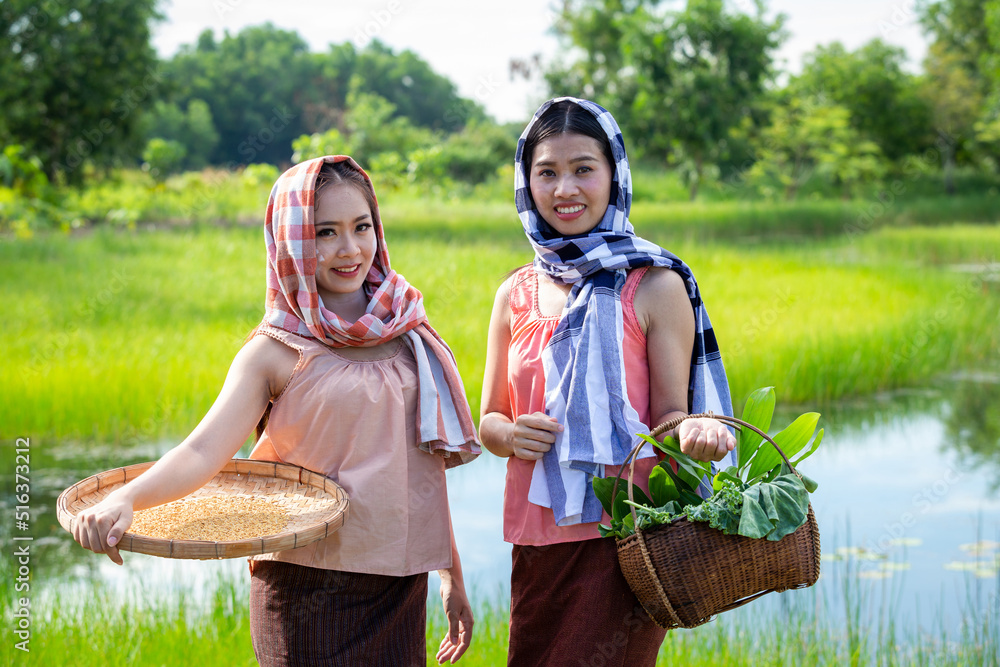 Portrait of beautiful young woman farmer wearing traditional costumes ...