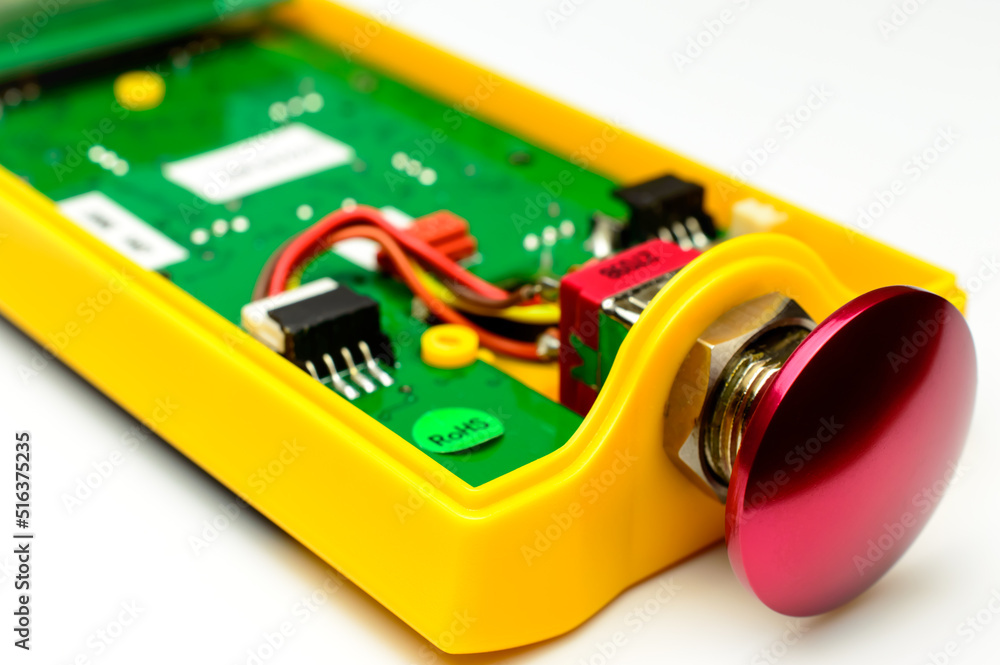 Macro photo of an emergency stop button on a remote controller for ship ...