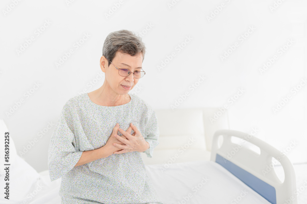 asian female patient feel tired in hospital, she use her hand touch on ...