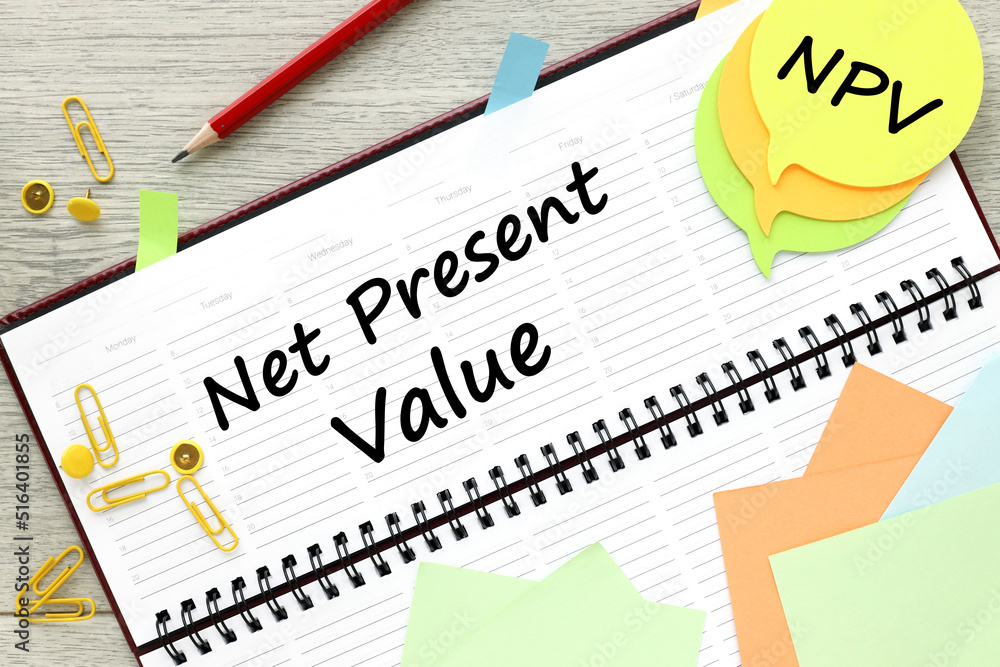 Net present value NPV documents on a table. wood background text on ...