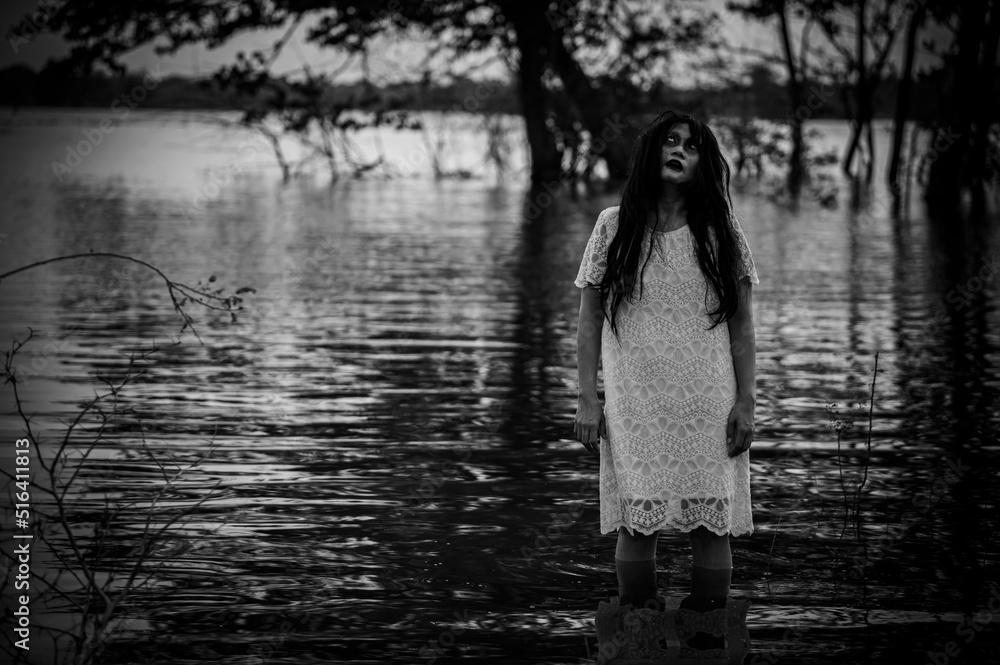 Portrait of asian woman make up ghost face at the swamp,Horror in water ...
