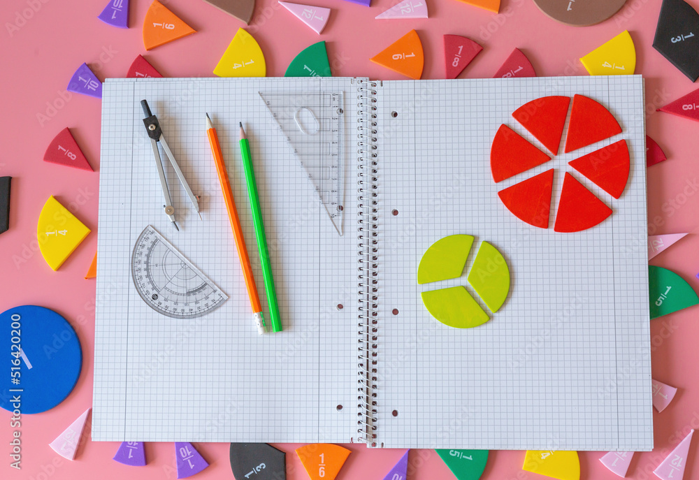 Back to school background. Open notepad, fractions, chart, pencils on a ...