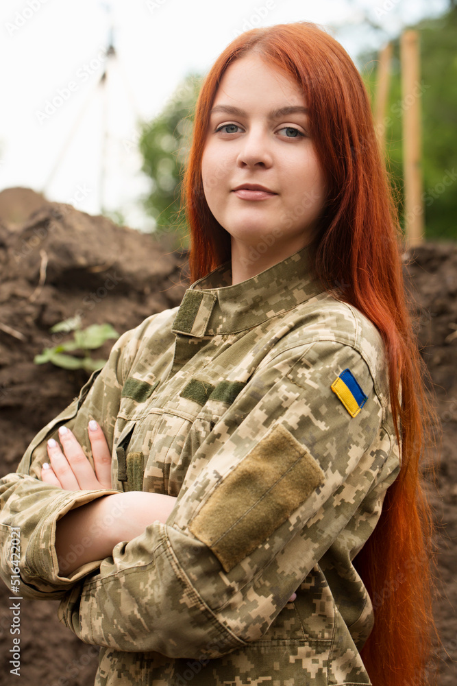 Long-haired girl in the military uniform of the armed forces of Ukraine ...
