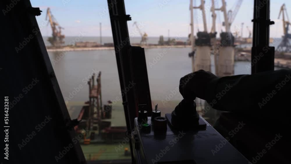 Man hands control joysticks at grain terminal operator cabin workplace ...