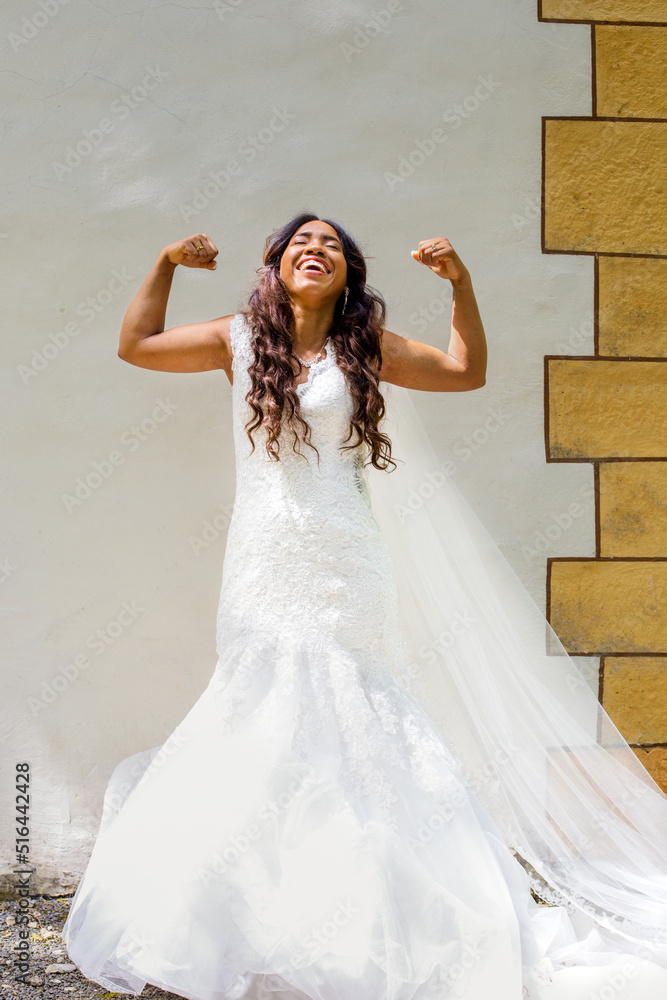 beautiful african-american bride standing in white gown and showing her ...