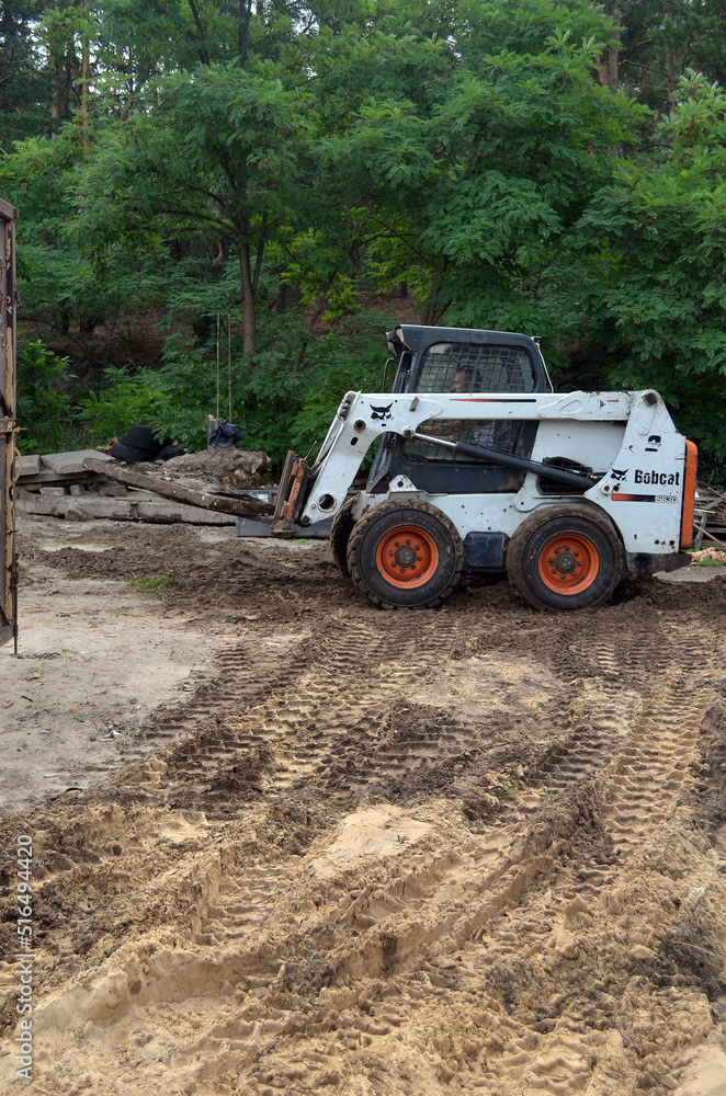 Bulldozer on old house rebuilding. 11 July 2022. Kiev Region, Ukraine ...