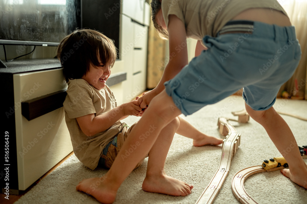 Two small children, brothers fighting over a toy. Conflict between ...