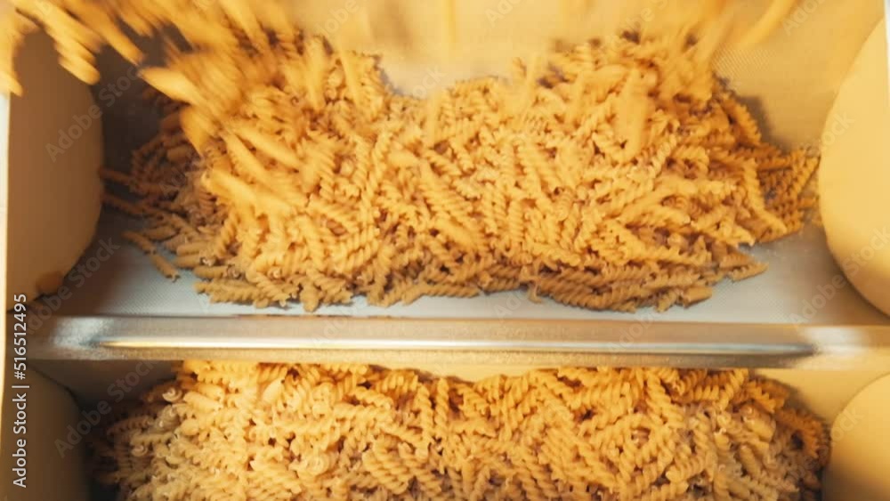 Pasta factory and pasta production stages. Close up of dry macaroni ...