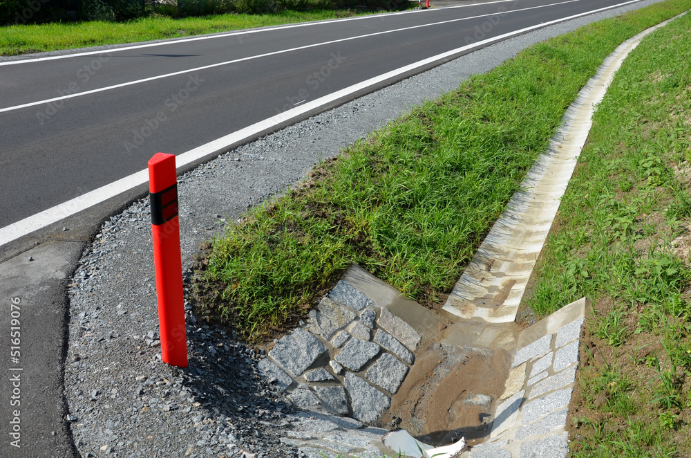 Sewer pipes under the bridge. crossing ditch by side road. concrete ...