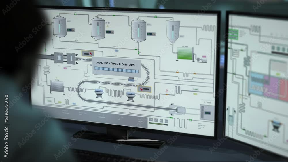 Engineer Monitors Automated Product Manufacturing Line Using Computer ...